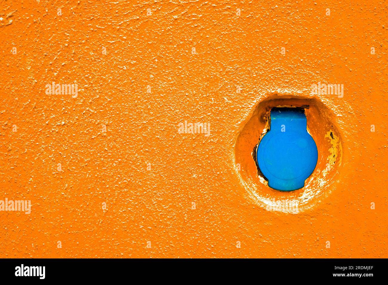 Blue electric socket in an orange wall, concept of connectivity Stock ...