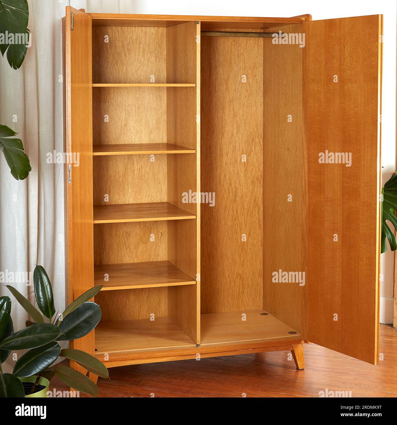 Vintage 1960s oak wood armoire. Mid Century Modern Furniture. Product photograph with large houseplants Stock Photo Alamy