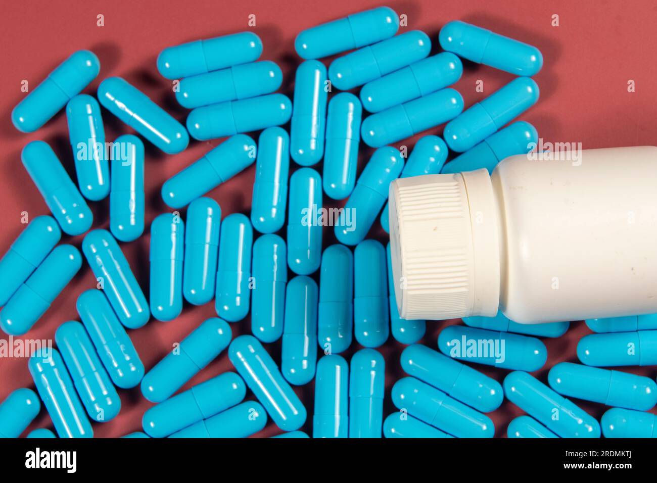 Blue antibiotic capsule pills texture with white bottle. Pharmaceutical ...