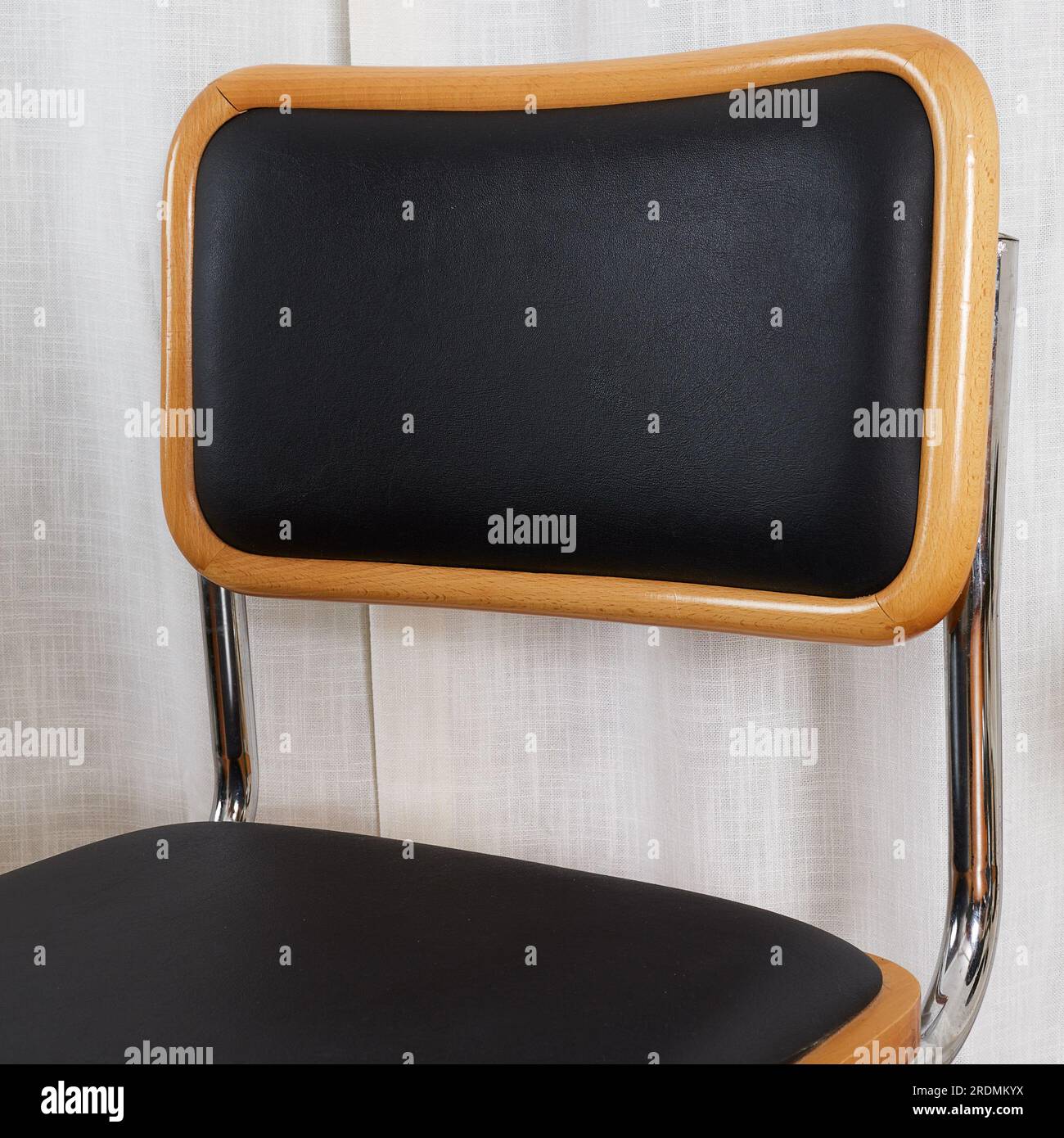 A black vinyl and chrome cantilever chair. Elegant Mid-Century Modern ...