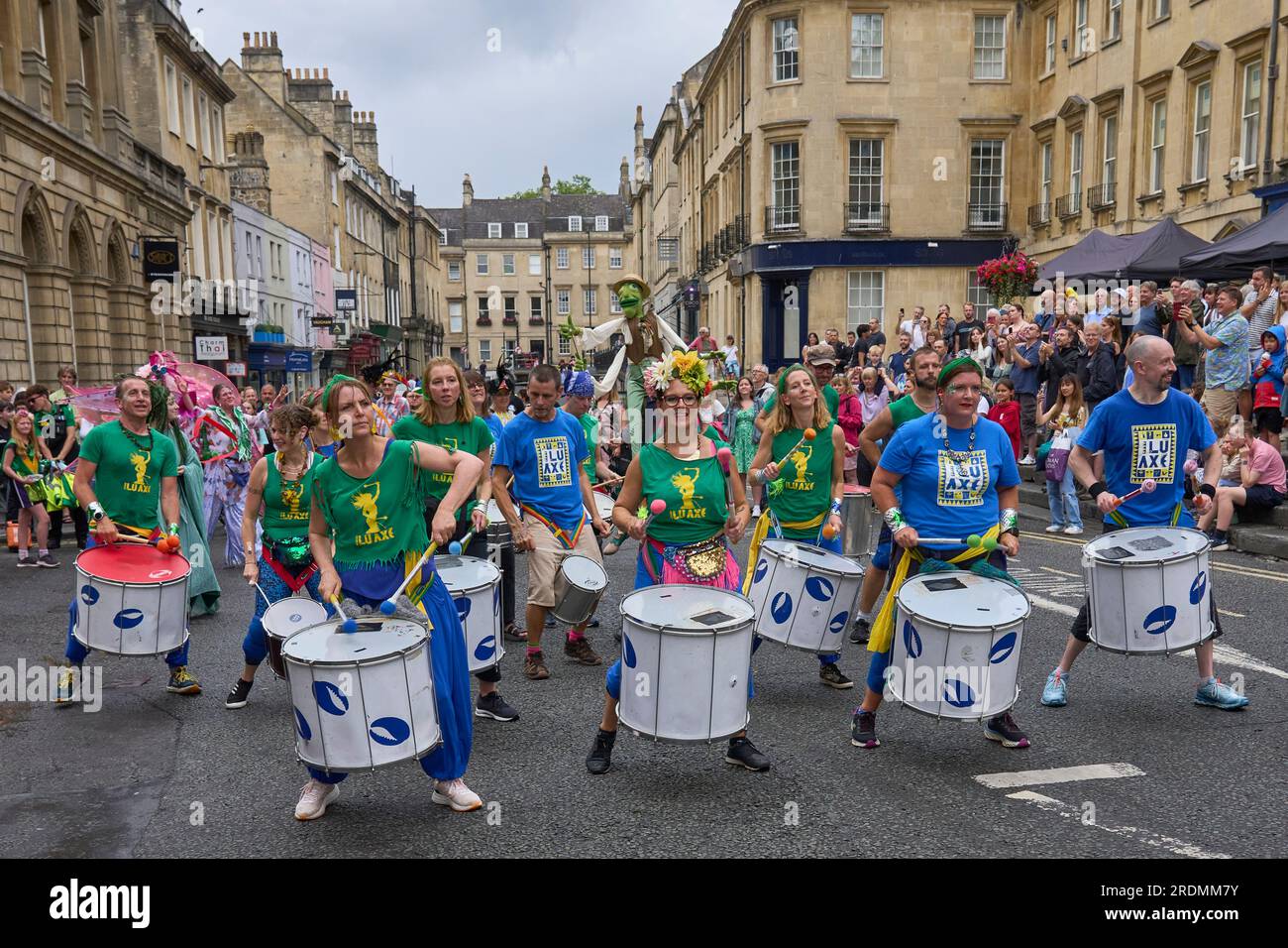 Dancers and musicians dressed in ornate costumes parade through the ...
