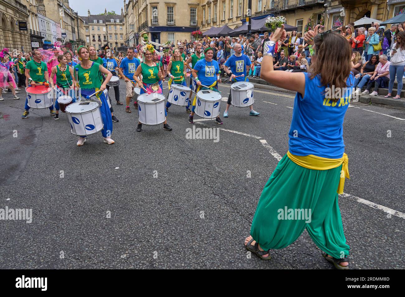 Dancers and musicians dressed in ornate costumes parade through the ...