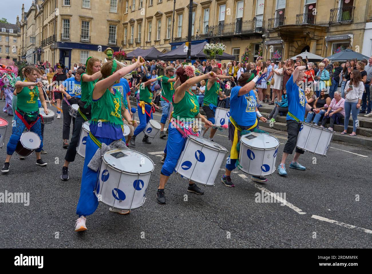 Dancers and musicians dressed in ornate costumes parade through the ...