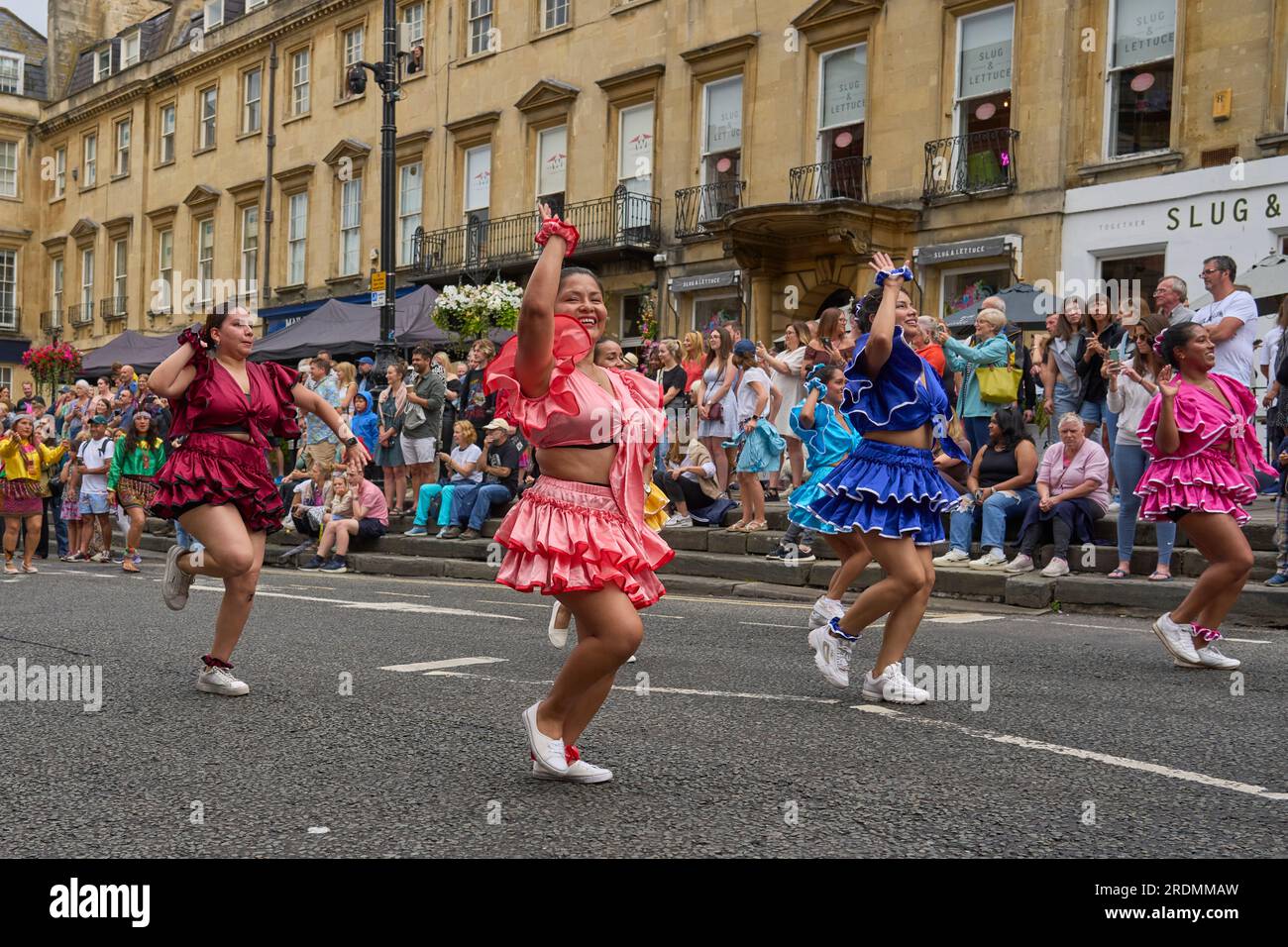 Dancers and musicians dressed in ornate costumes parade through the ...