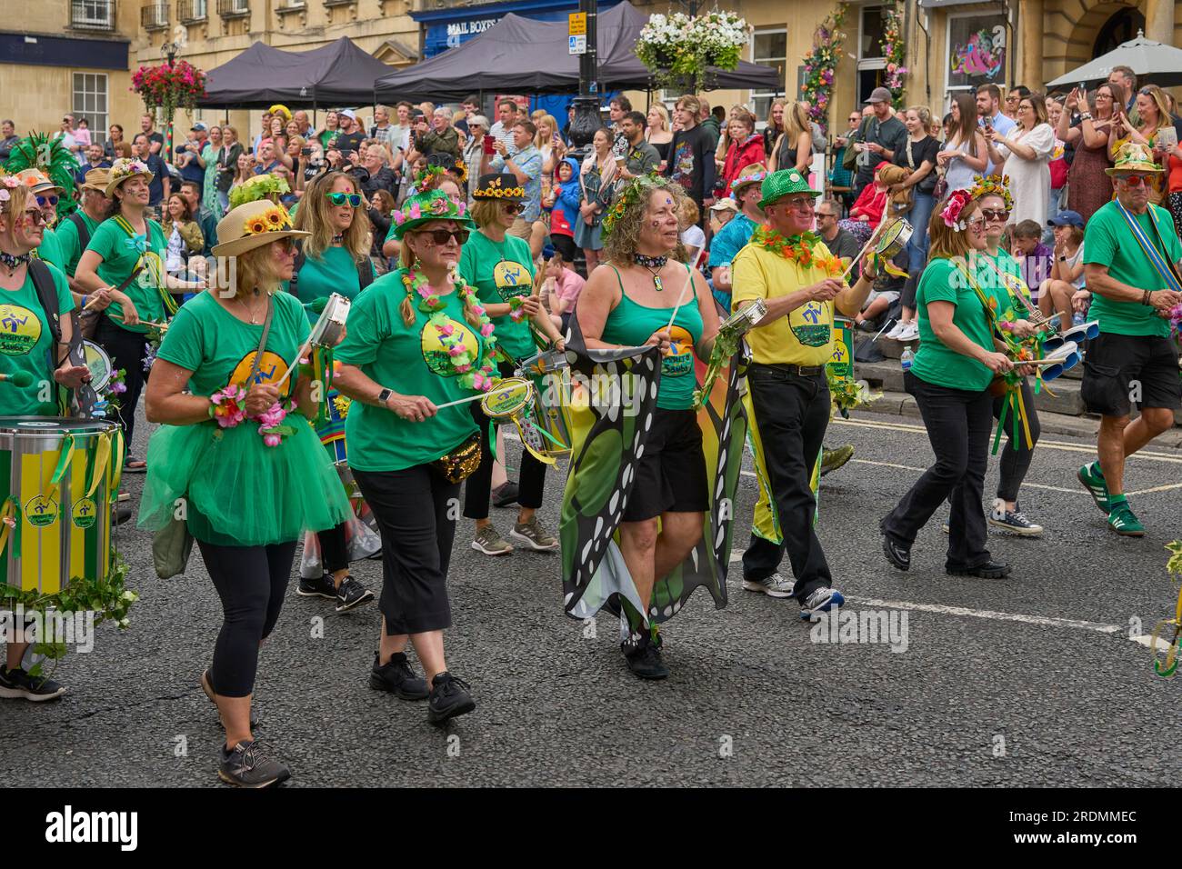 Dancers and musicians dressed in ornate costumes parade through the ...