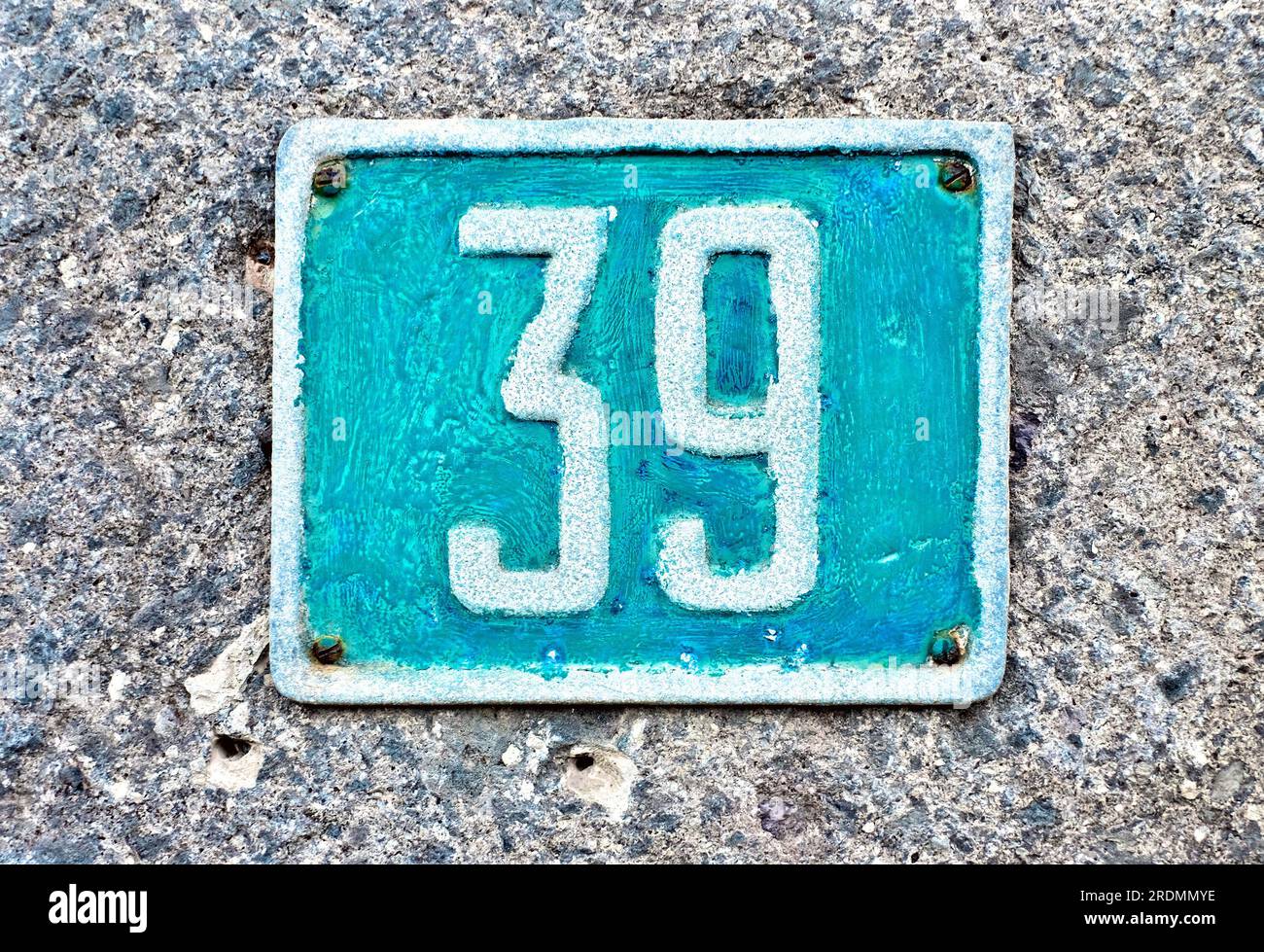 Number 39, thirty-nine, light blue plate on gray stone surface Stock ...