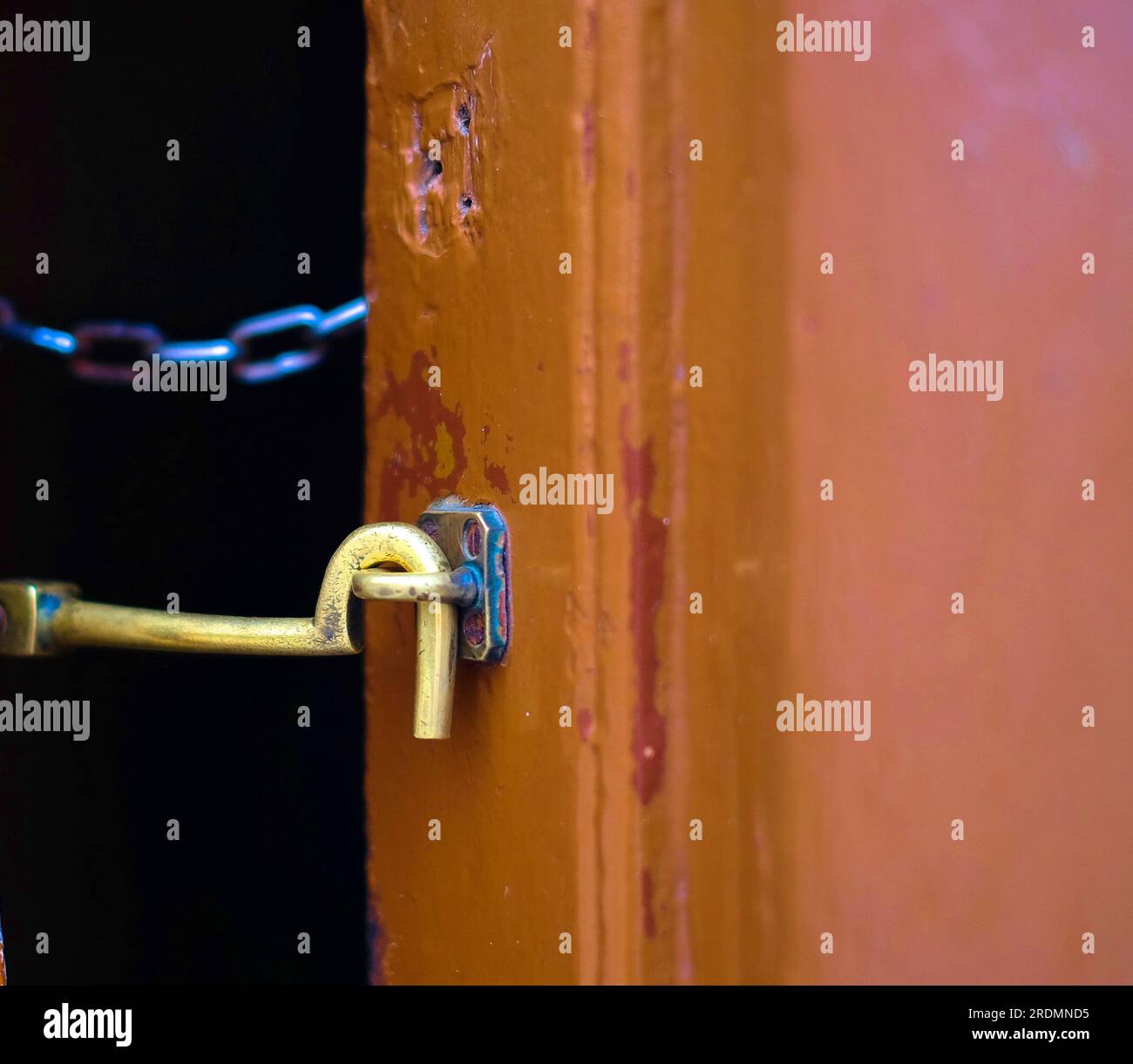 Door ajar secured with a hook and a chain Stock Photo - Alamy
