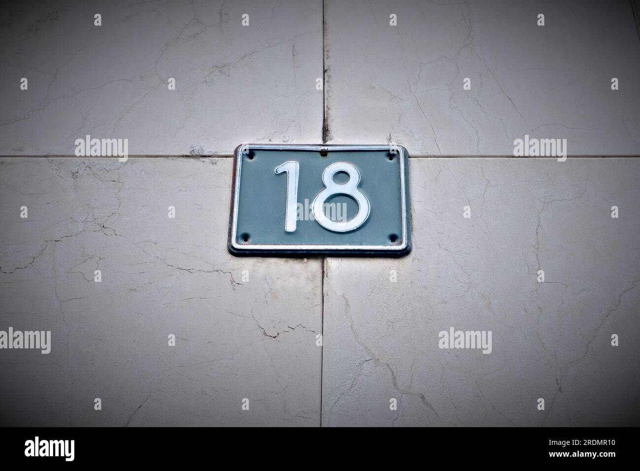 Number 18, eighteen, blue blate on pale background, vignette effect ...