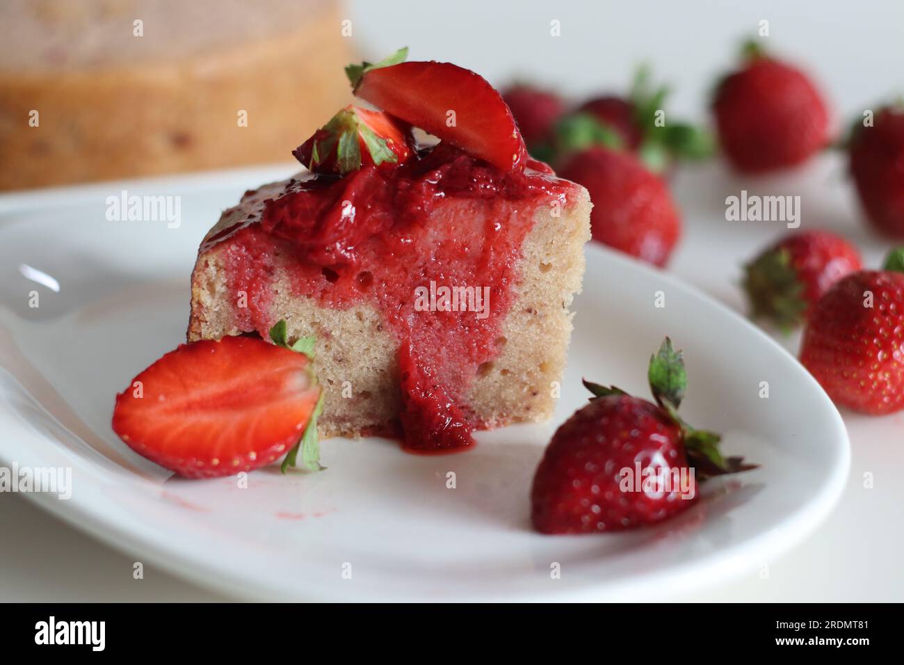 Slices of strawberry cake. A simple tea time cake, flavored with fresh ...