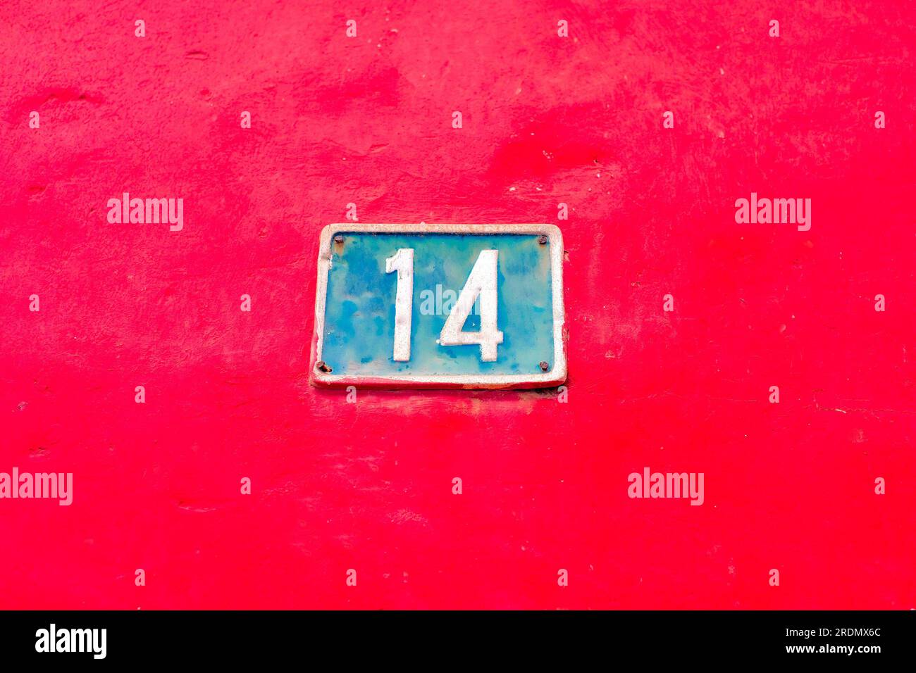 Number 14, fourteen, blue plate on bold red background Stock Photo - Alamy