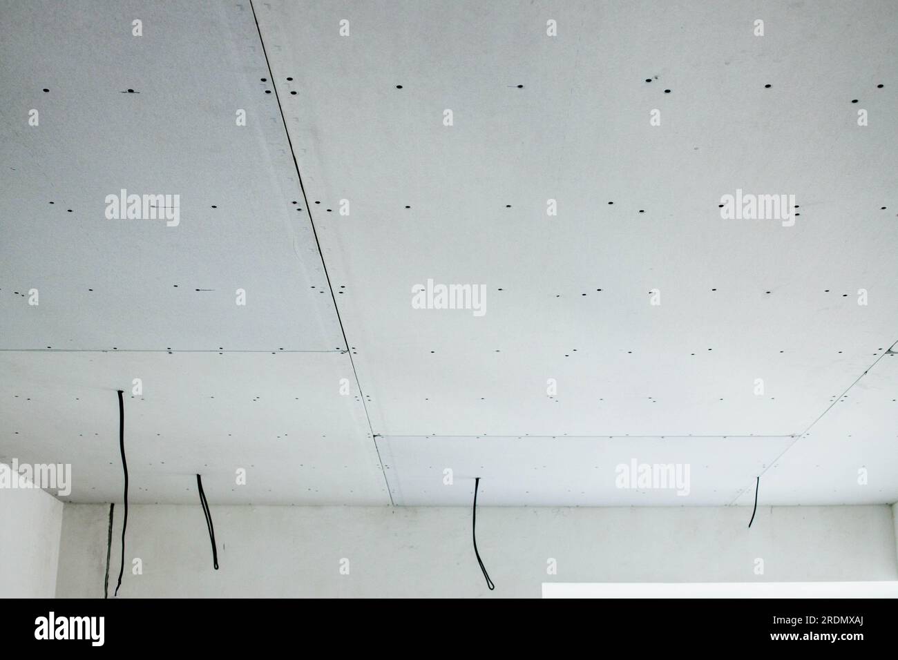 Finishing installation of suspended ceiling at the construction site ...