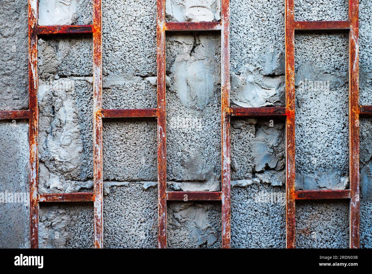 Rusty bars over gray concrete blocks, an abstract fragment of old ...