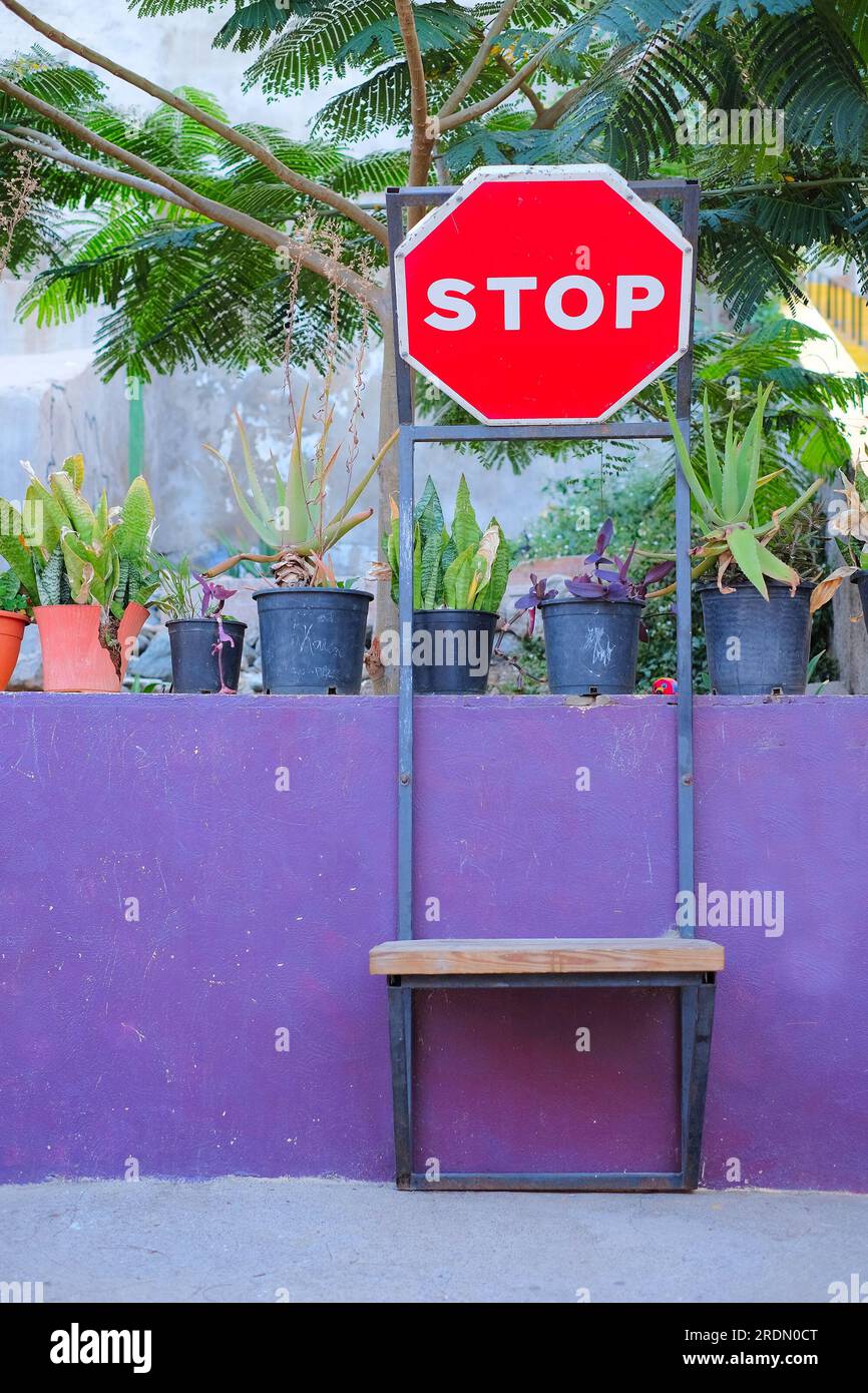 A bench and a stop sign, a place to slow down, sit and relax in a small ...