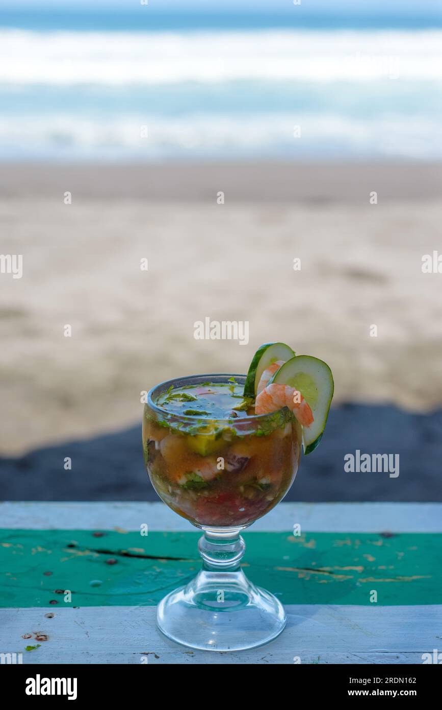 Shrimp cocktail with beach landscape in background. Blurred background ...