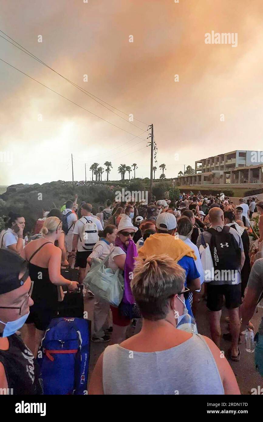 Tourists are being evacuated during a forest fire on the island of ...