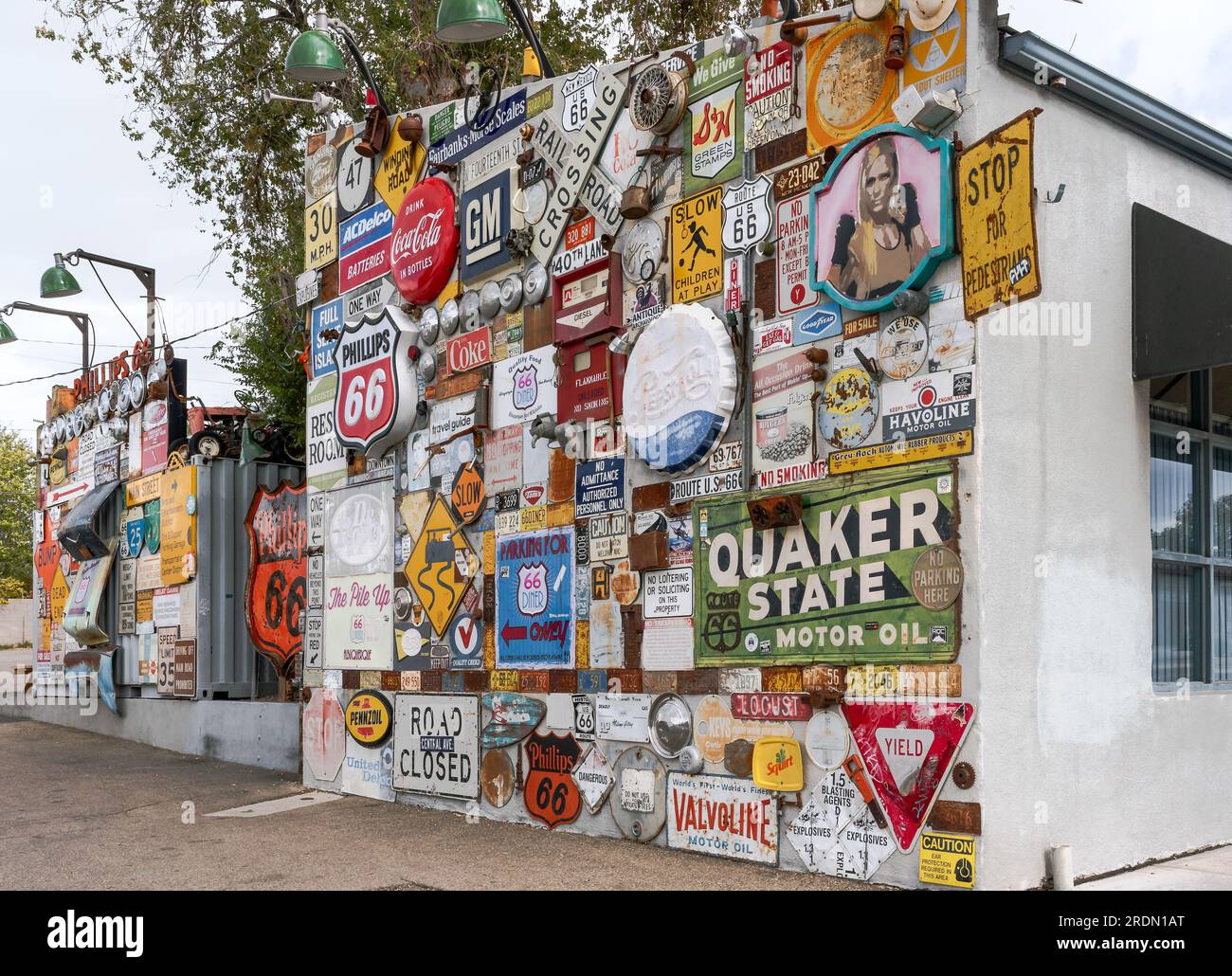 The facade of a building covered in signs and memorabilia from Route 66 ...