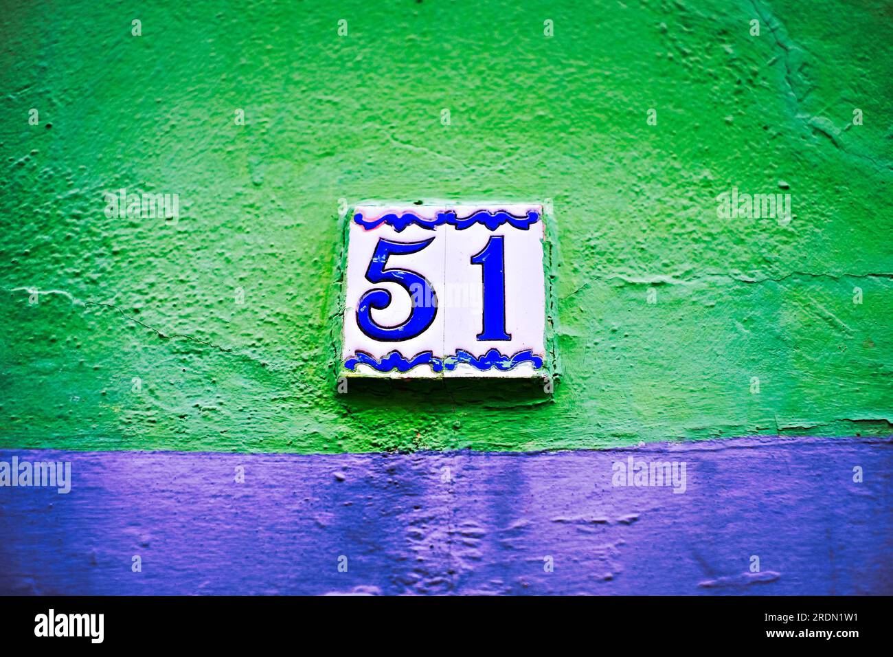 Number 51, fifty-one, old decorative tiles on green and blue background ...