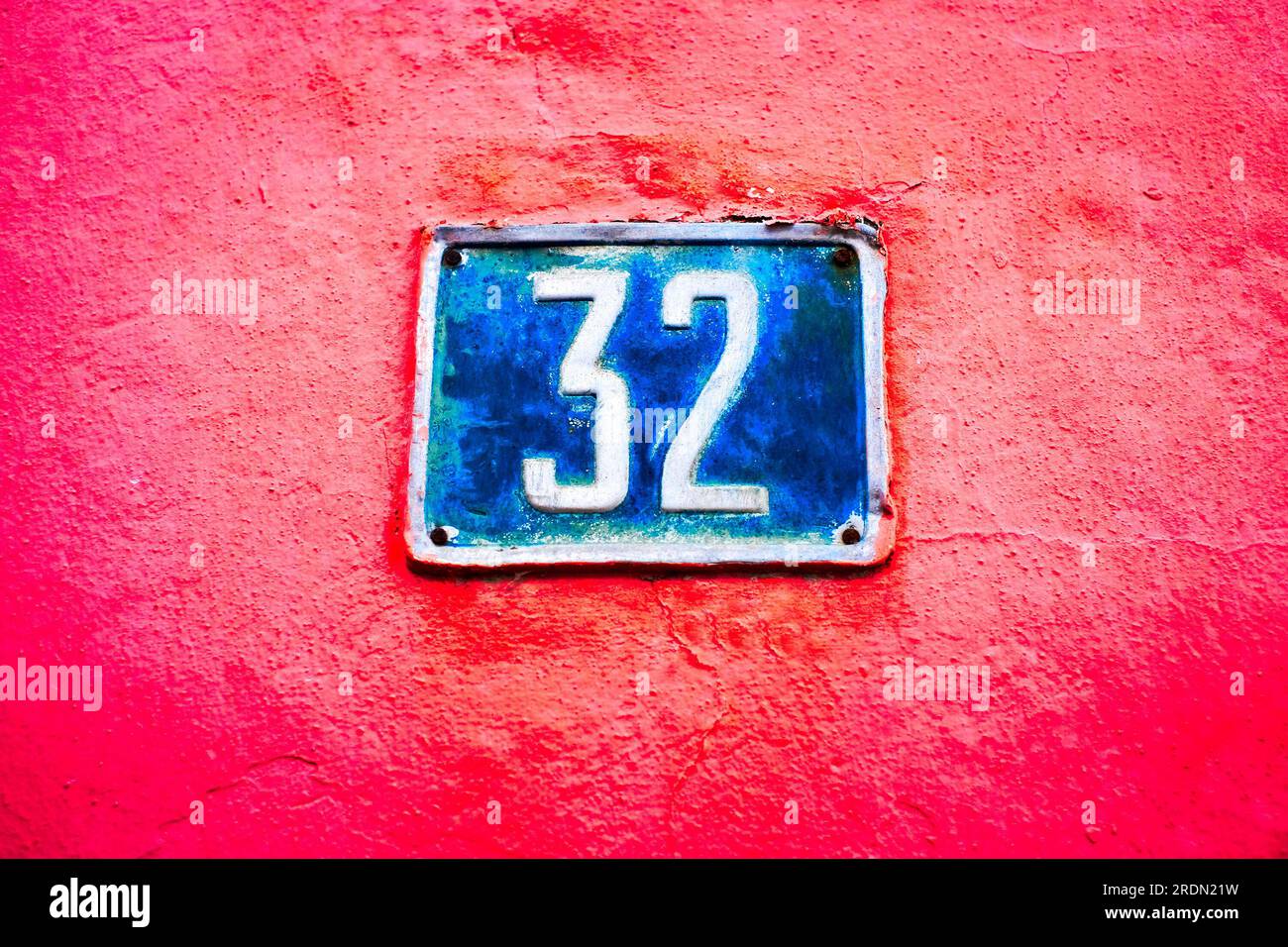 Number 32, thirty-two, blue on neon pink background Stock Photo - Alamy