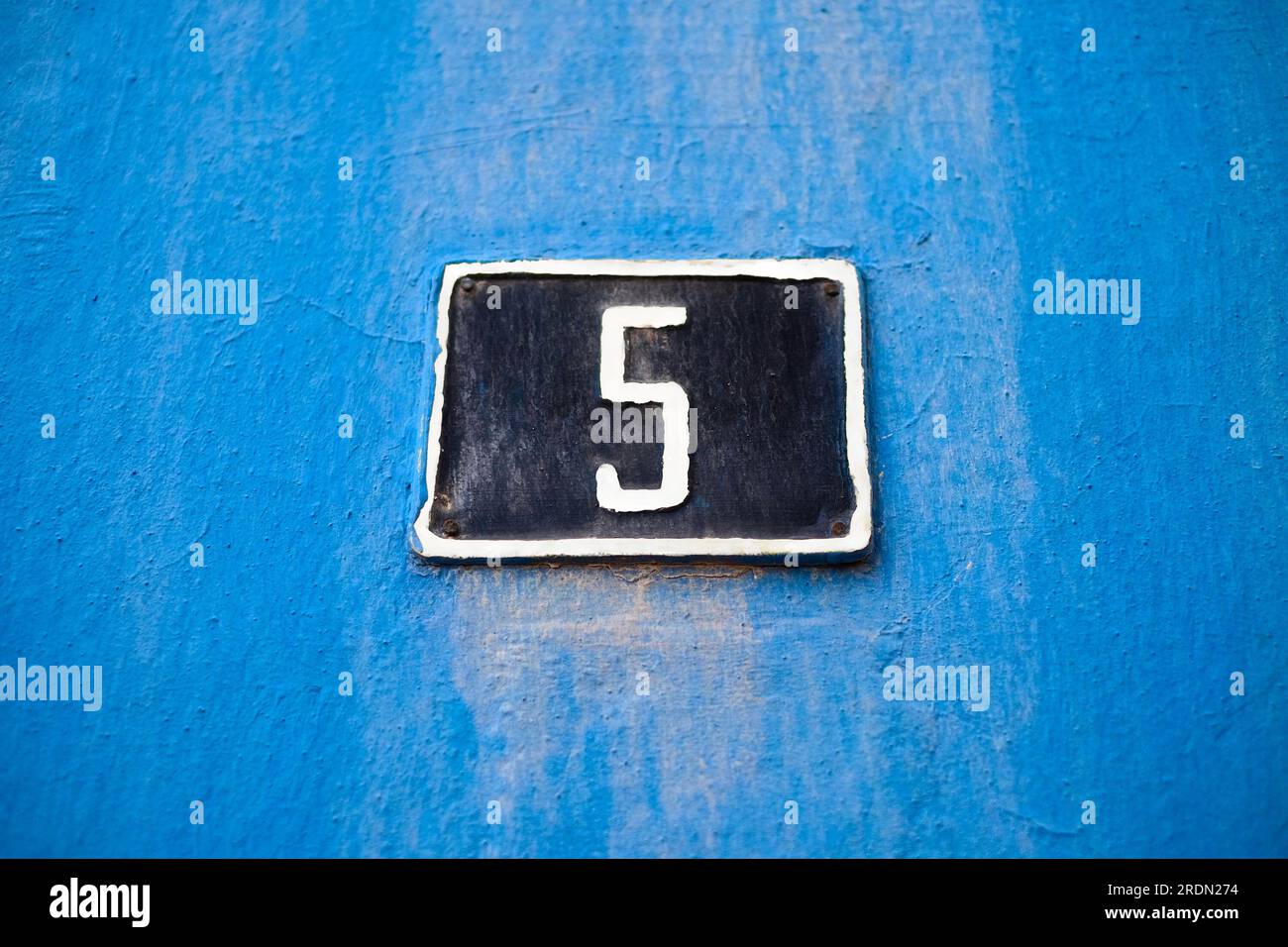 Elegant number 5, five, dark blue plate on light blue weathered ...