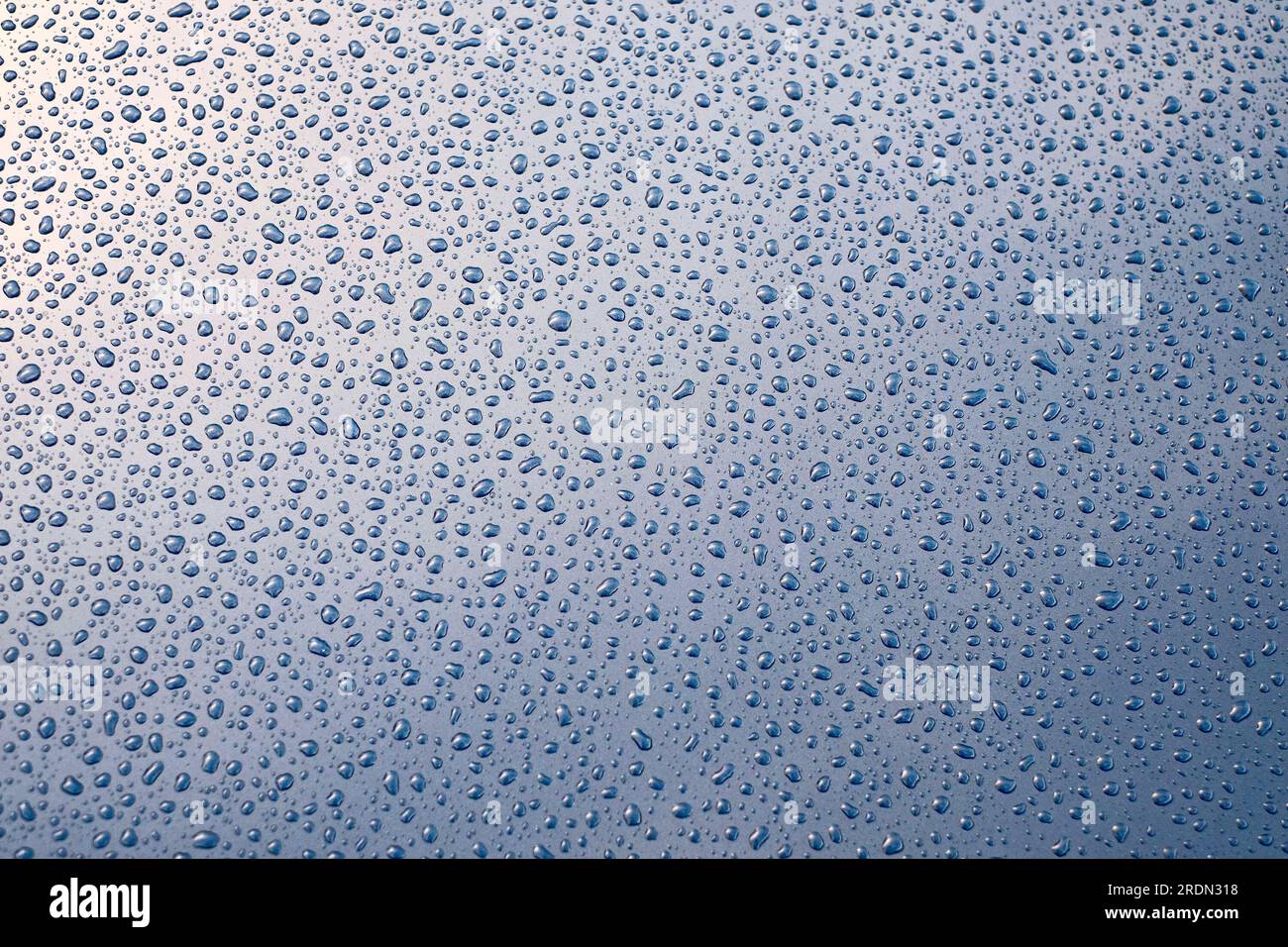 Blue glossy reflective surface and fine random droplets of shower water ...