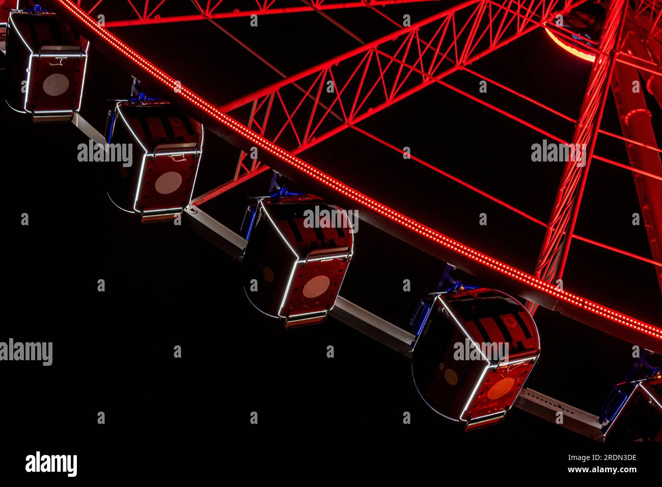 part of a big wheel in red light at night Stock Photo - Alamy