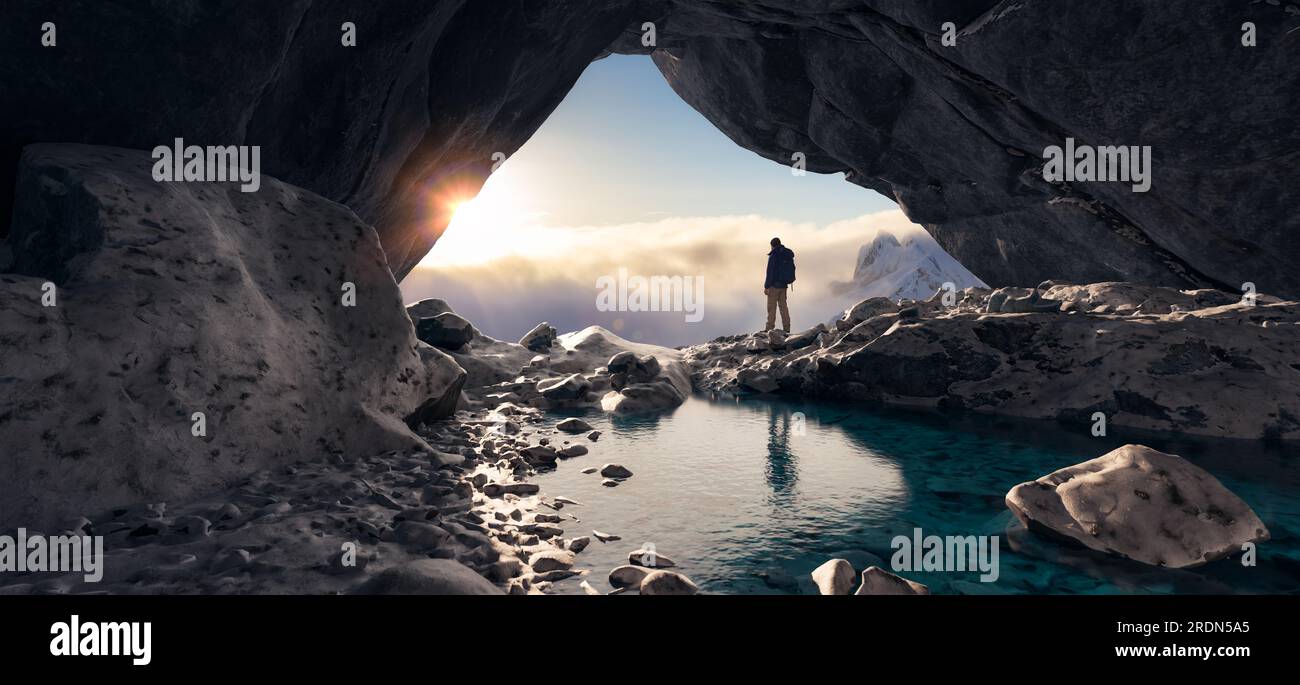 Adventurous Man Standing in cave on top of Mountain. Extreme Adventure ...