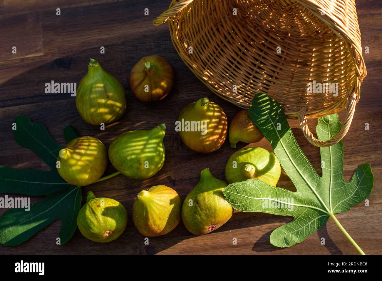 A few yellow figs on an brown wooden background in sunshine Stock Photo ...