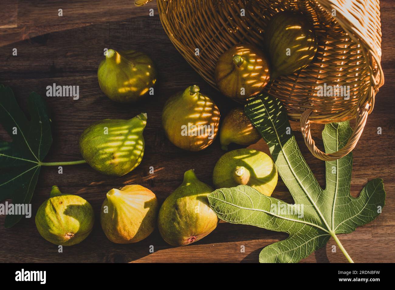 A few yellow figs on an brown wooden background in sunshine Stock Photo ...