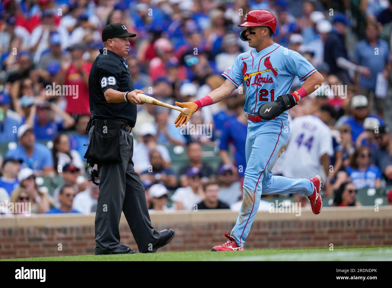 St. Louis Cardinals' Lars Nootbaar, right, grabs a bat from umpire Cory ...