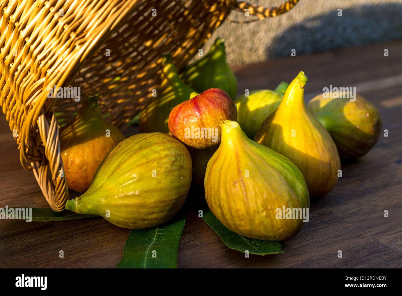 A few yellow figs on an brown wooden background in sunshine Stock Photo ...
