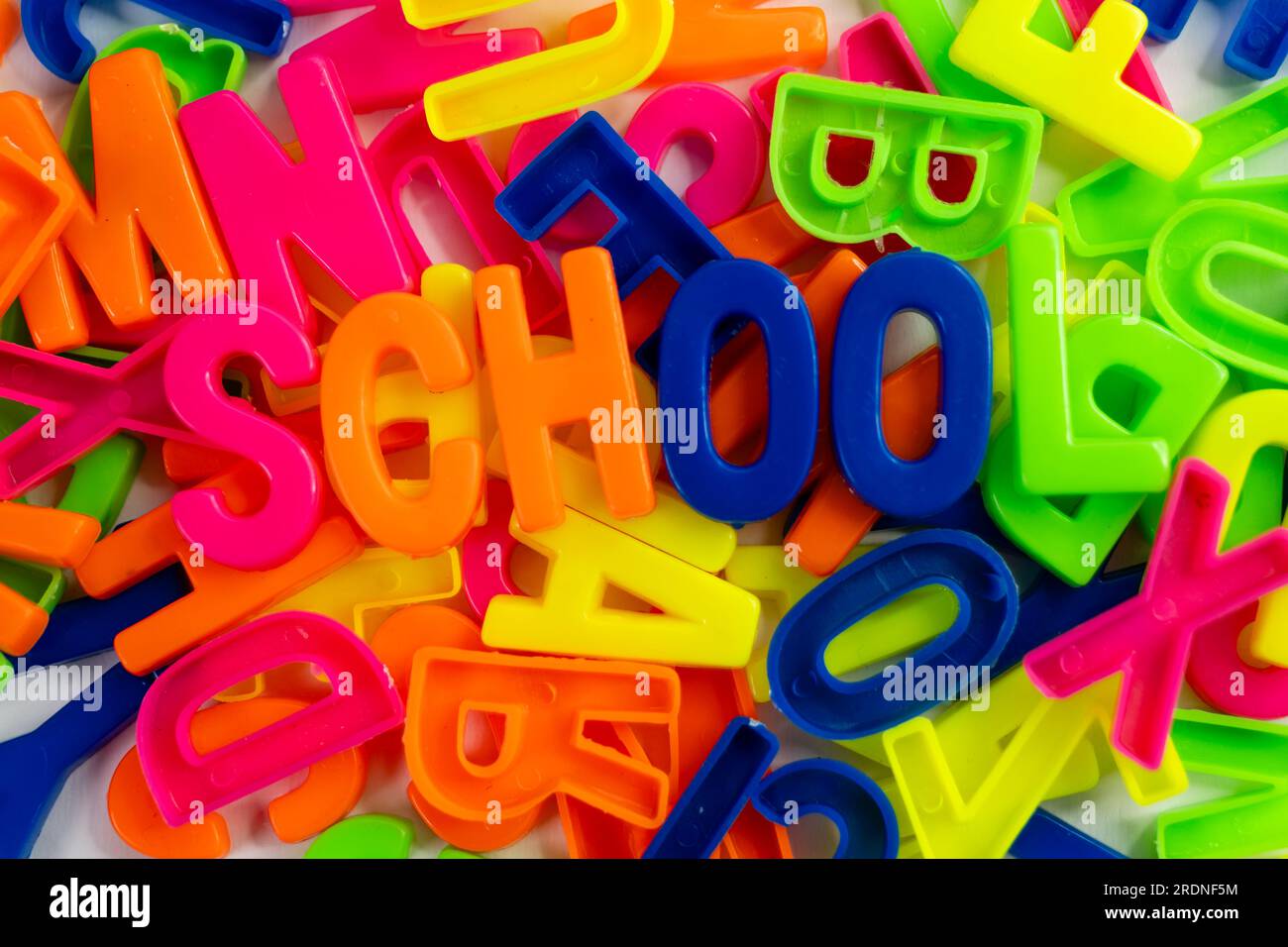 This stock image shows a set of colorful letter magnets arranged to ...