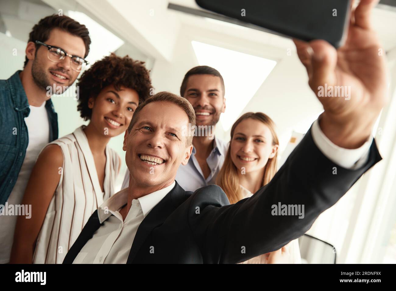 Successful team Group of smiling colleagues taking selfie while ...