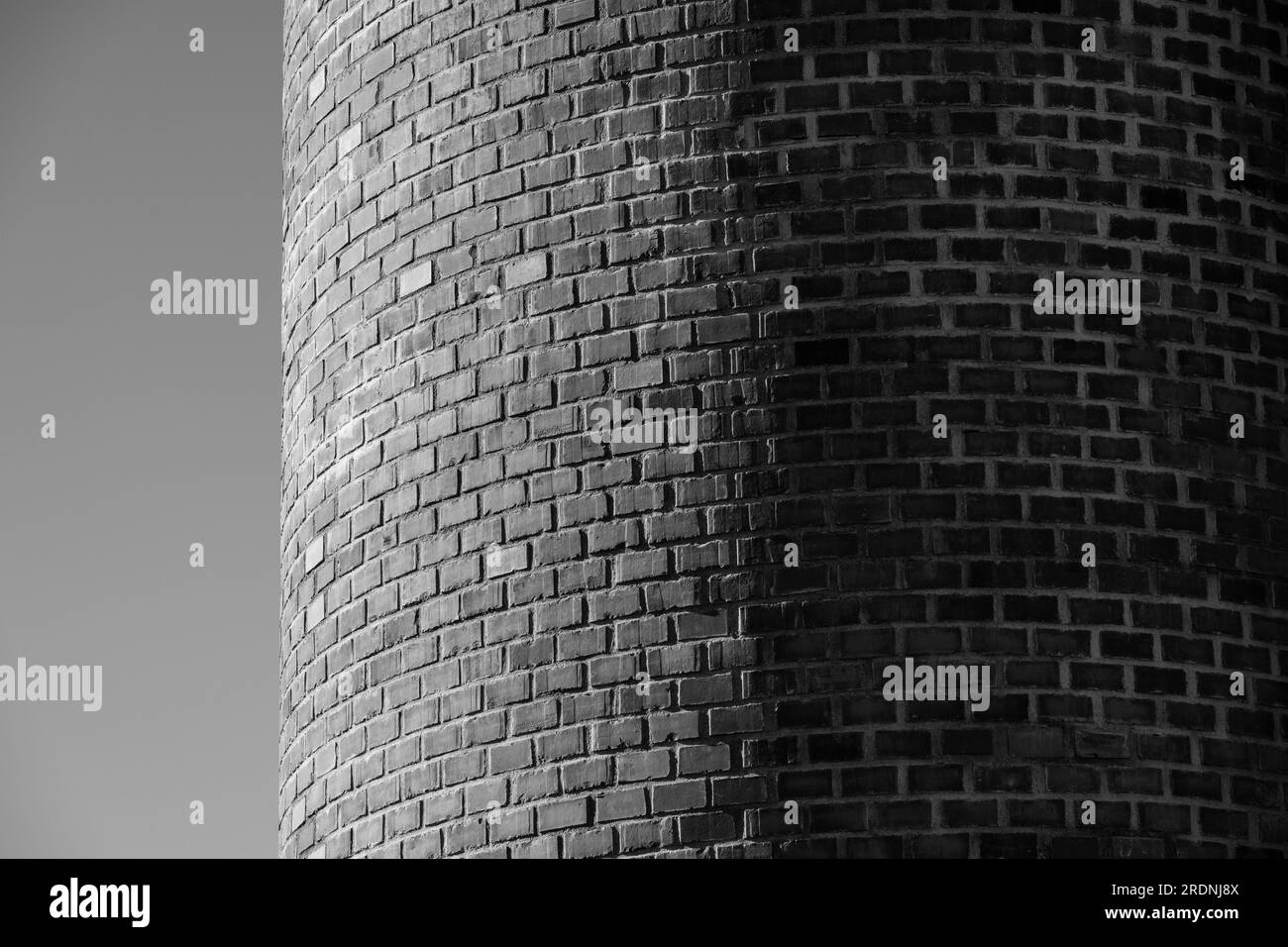 Red round brick smokestack in sunlight Stock Photo - Alamy