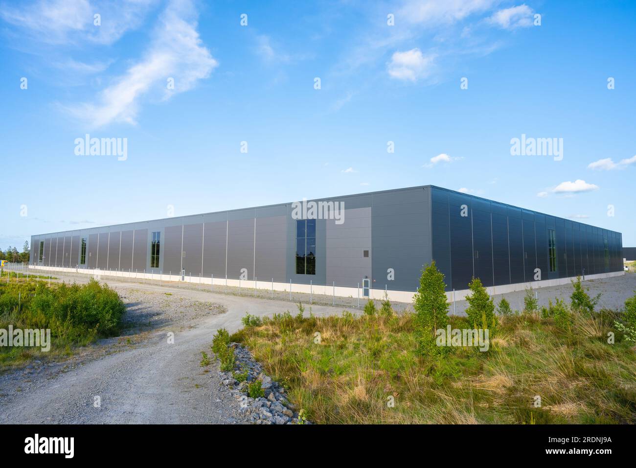 Exterior of a new and large grey warehouse Stock Photo - Alamy