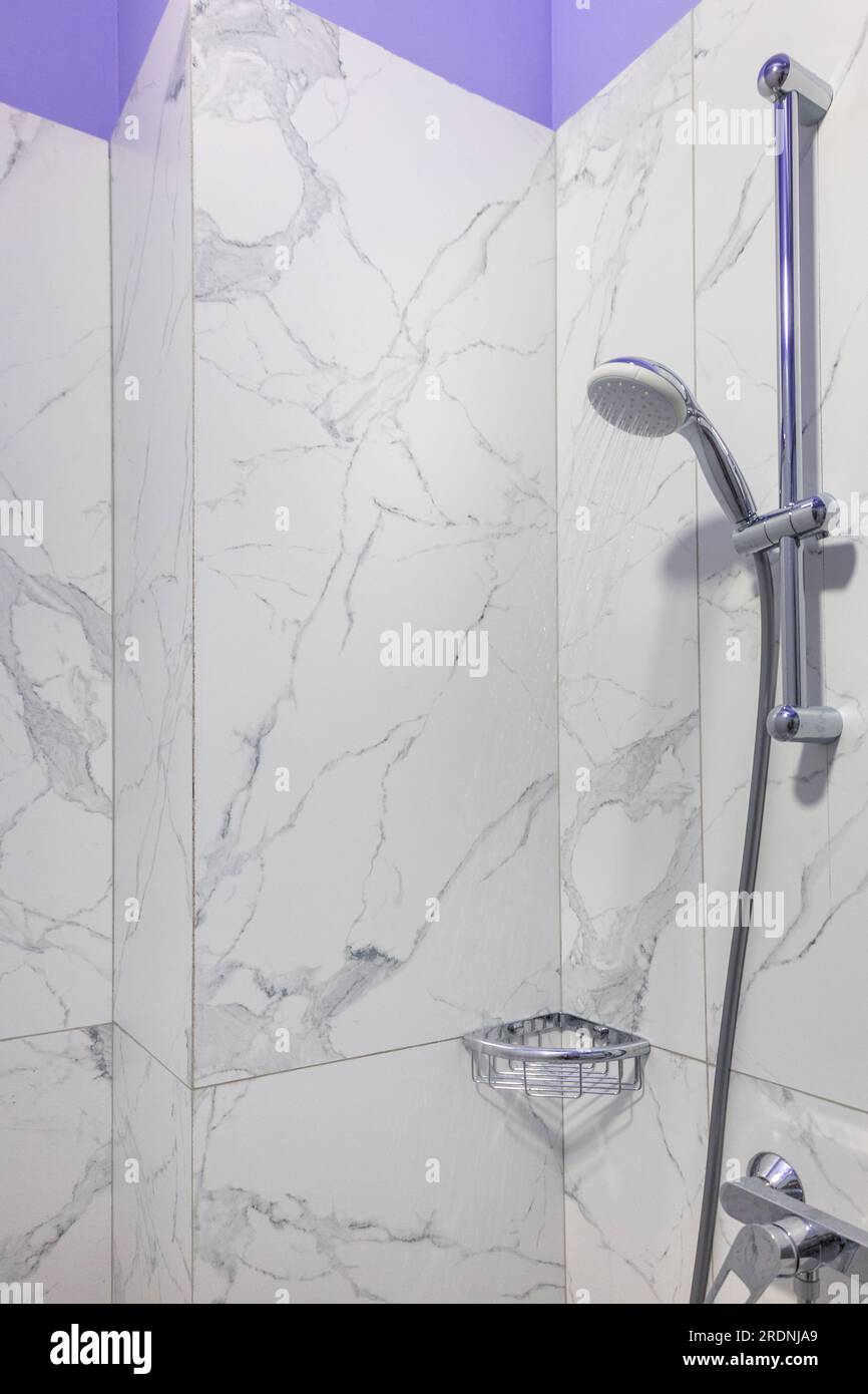 Stream of water splashing out of shower in modern bathroom. Jets of ...