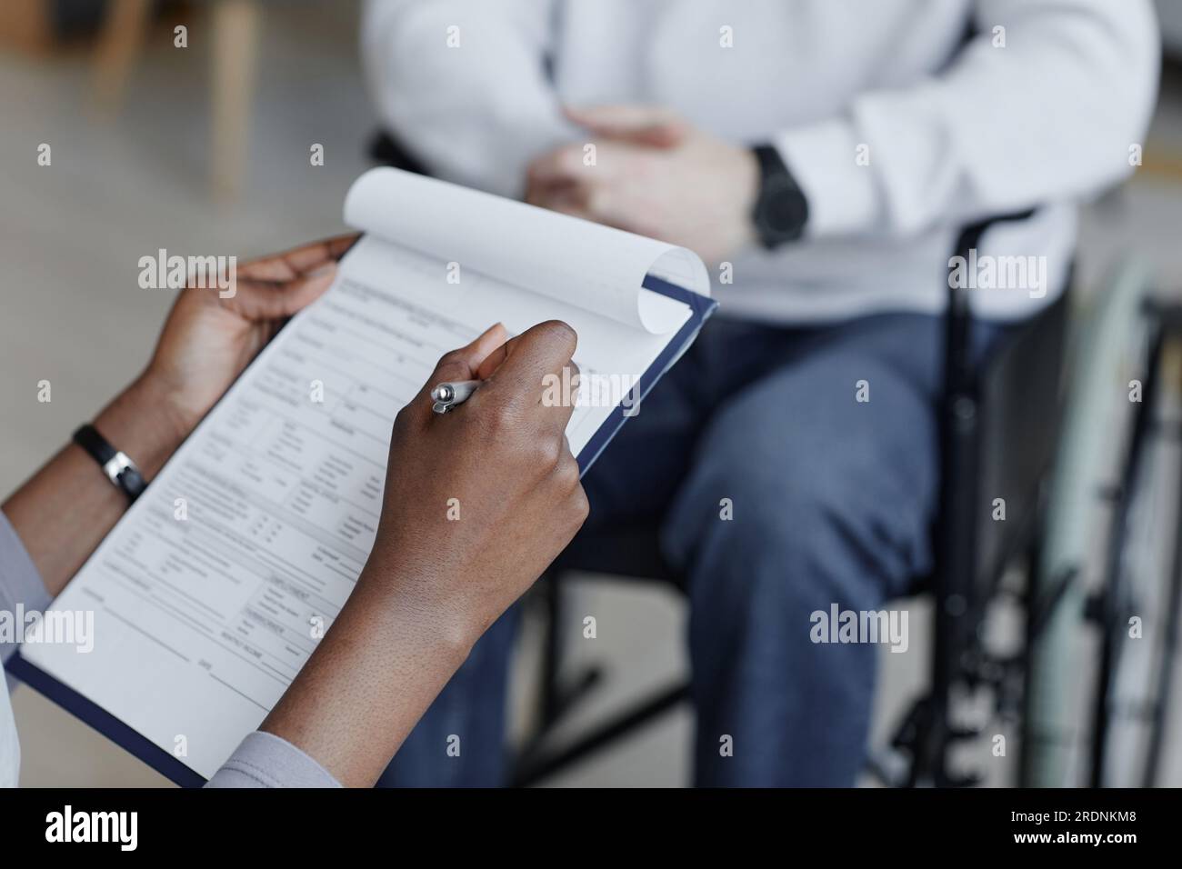 Closeup of unrecognizable nurse holding clipboard with patients chart ...
