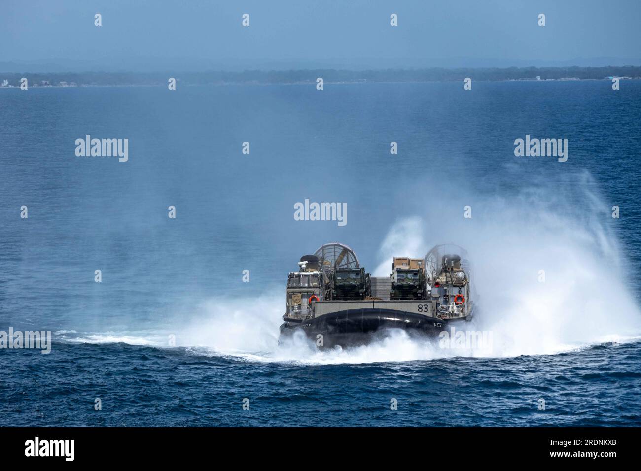 U.S. Navy Landing Craft Air Cousin (LCAC) 83 transports U.S. Marine Corps 7-tons back aboard San ...
