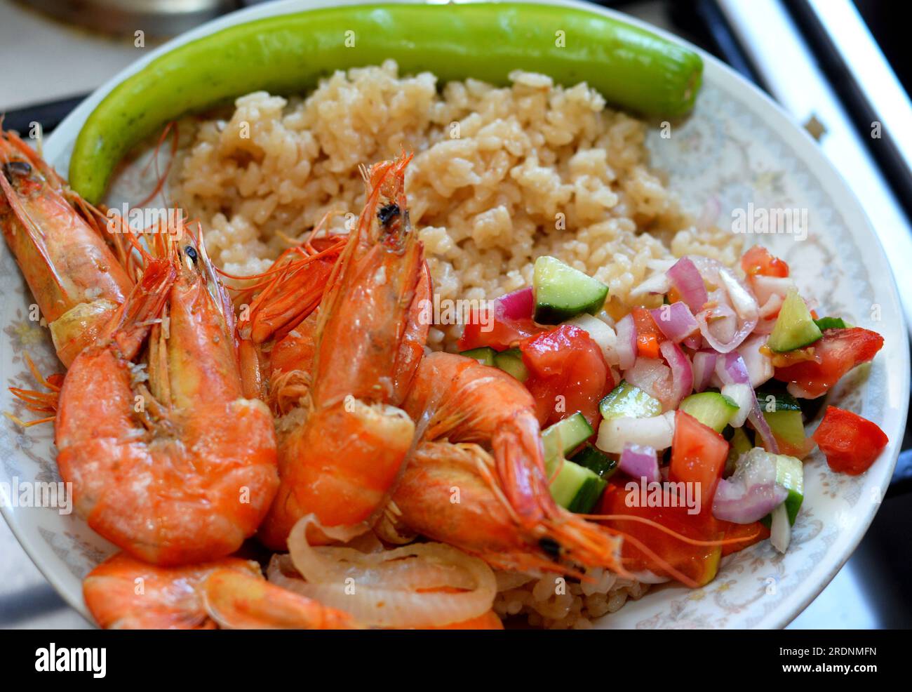 Egyptian rice cooked on hot steam, green salad, pepper, cooked shrimps ...