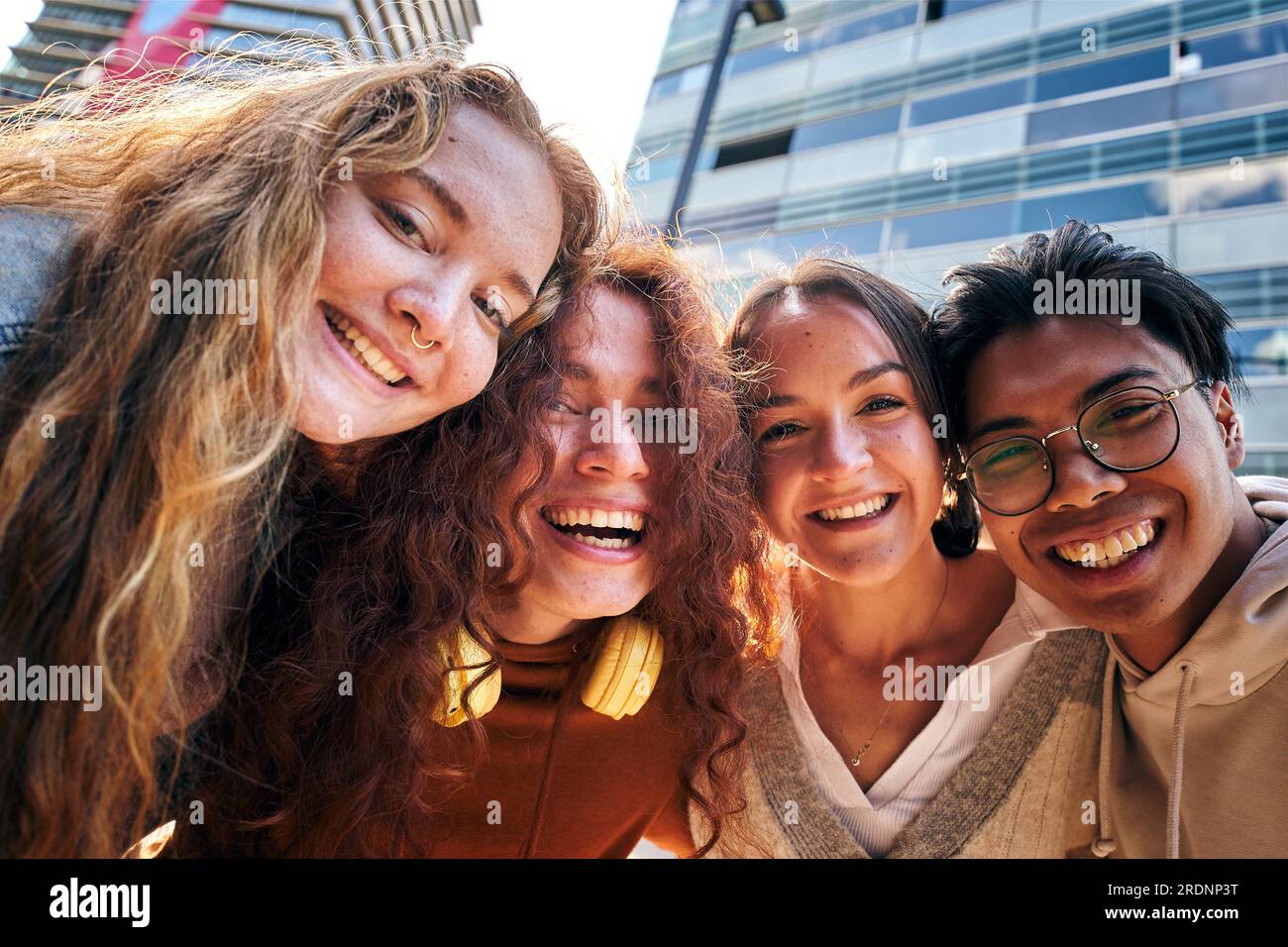 Group of friends taking selfie picture smiling looking at camera ...