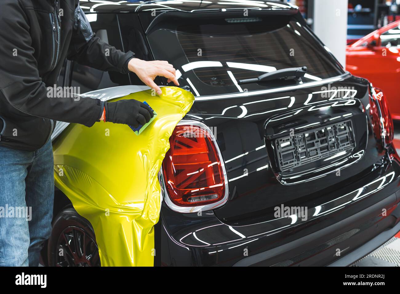 Back and truck of a car during car wrapping process at detailing ...