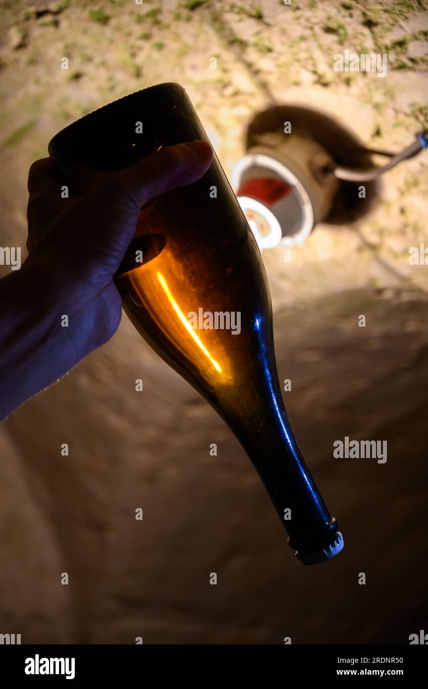 Checking of sediment in undergrounds caves with bottles on wooden racks ...