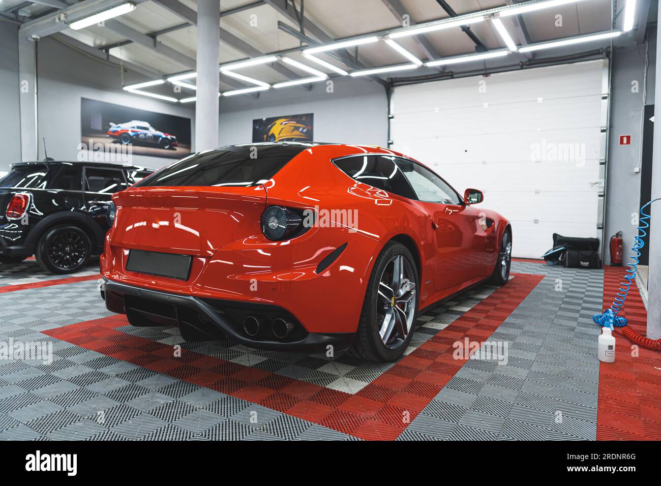 full back view of a red modern car at the repair shop. High quality ...