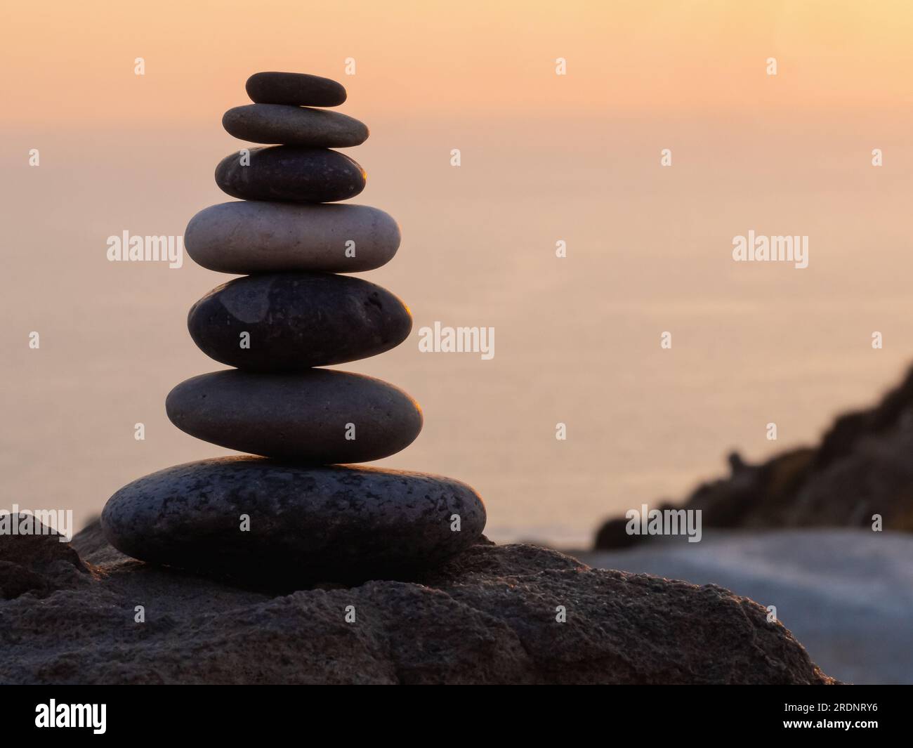 cairn at sunset, stones balances, pyramid of stones at sunset, concept ...
