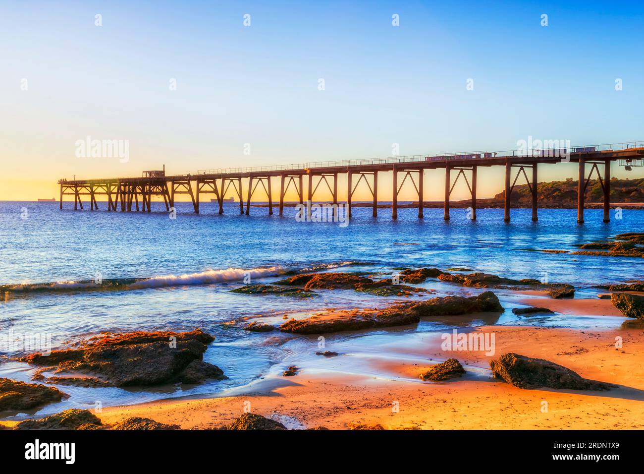 Long historic jetty at Middle Camp beach of Catherine hill bay coastal ...