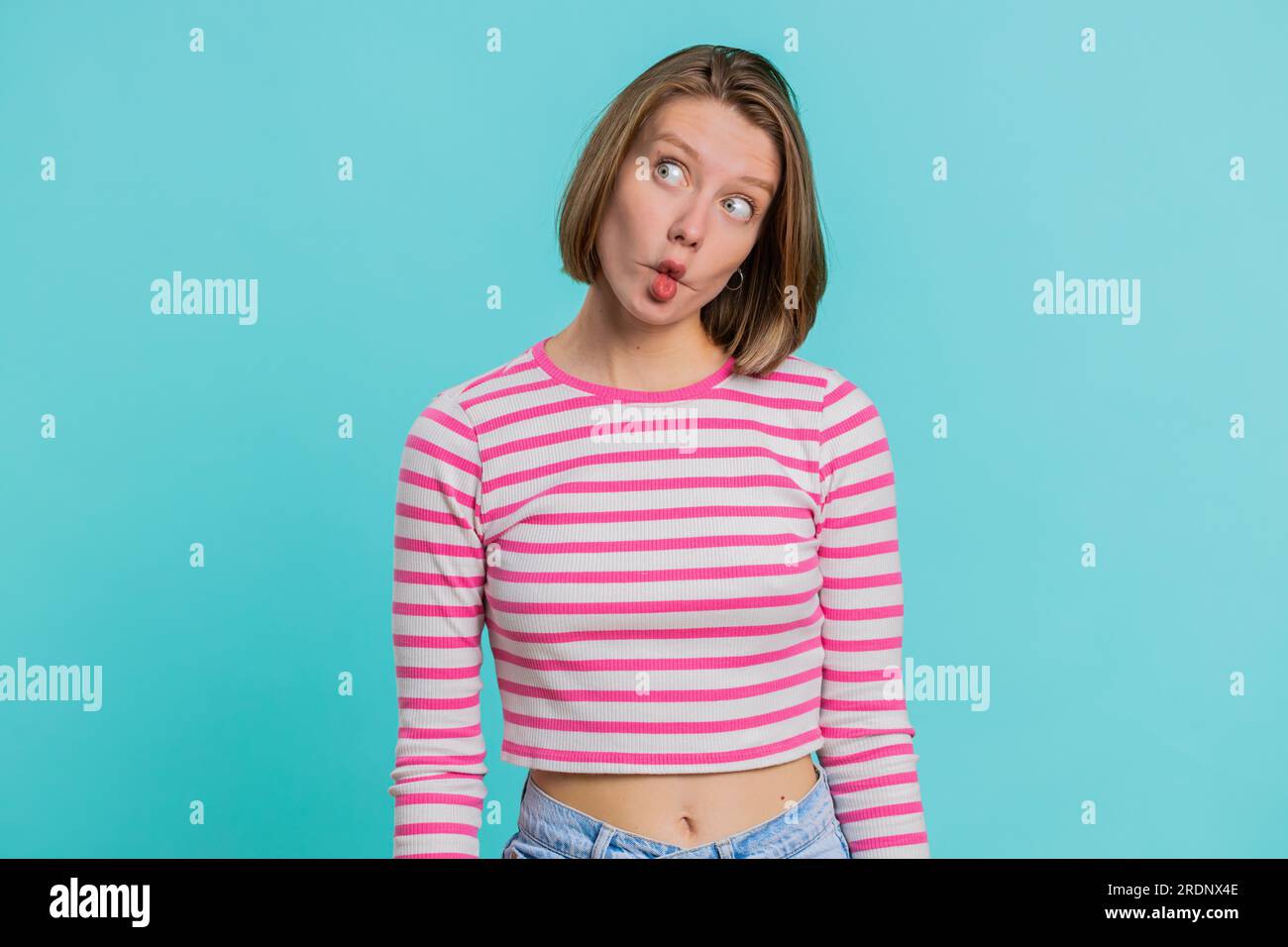 Surprised funny comical playful young woman making fish grimace pout ...