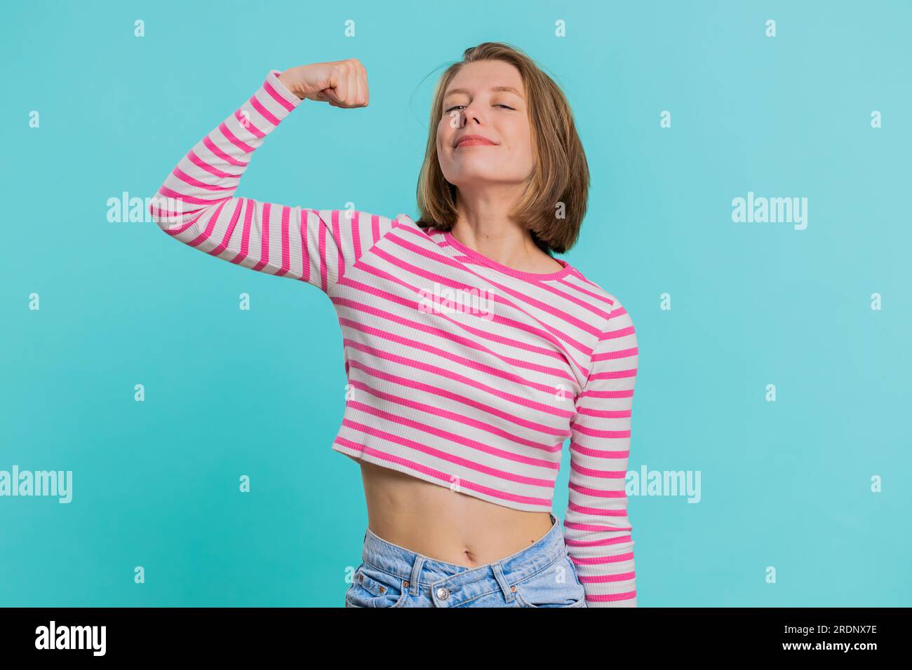I am strong and independent. Young woman showing biceps and looking ...