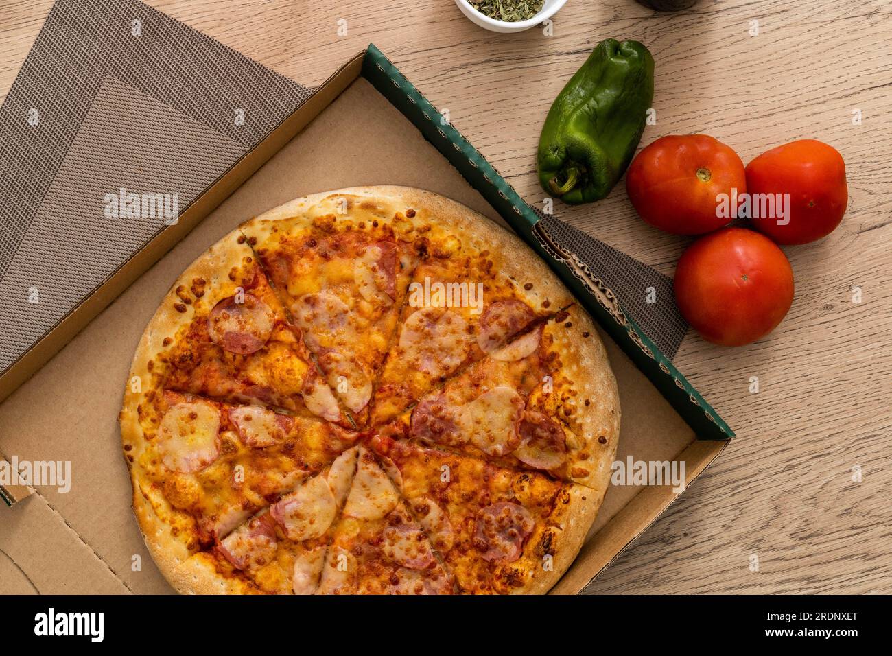 approach to exquisite pizza ready to eat packed in its box, restaurant ...