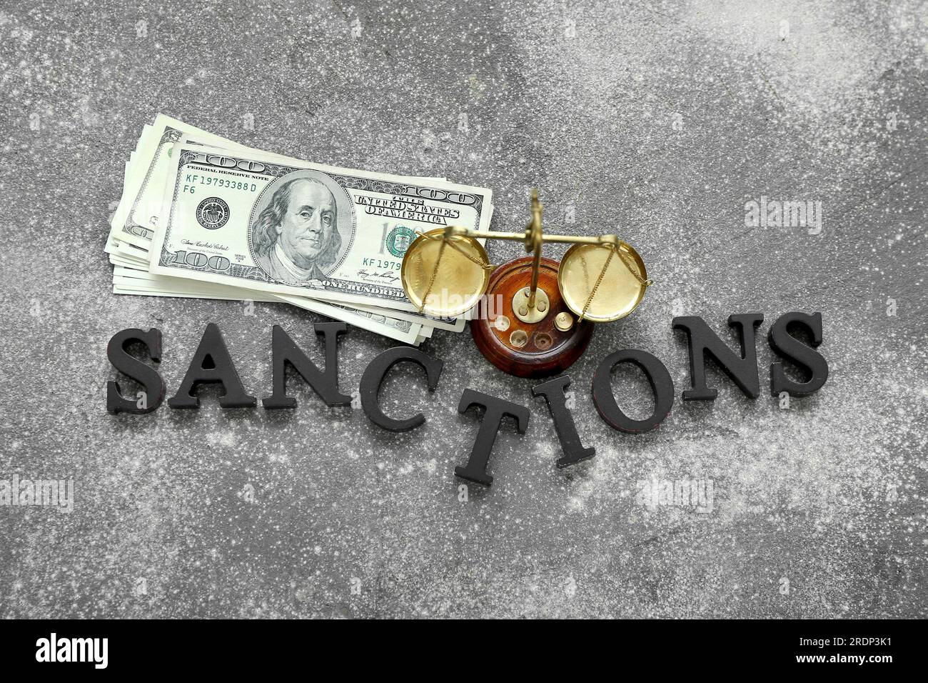 Word SANCTIONS with justice scales and dollar banknotes on dark ...