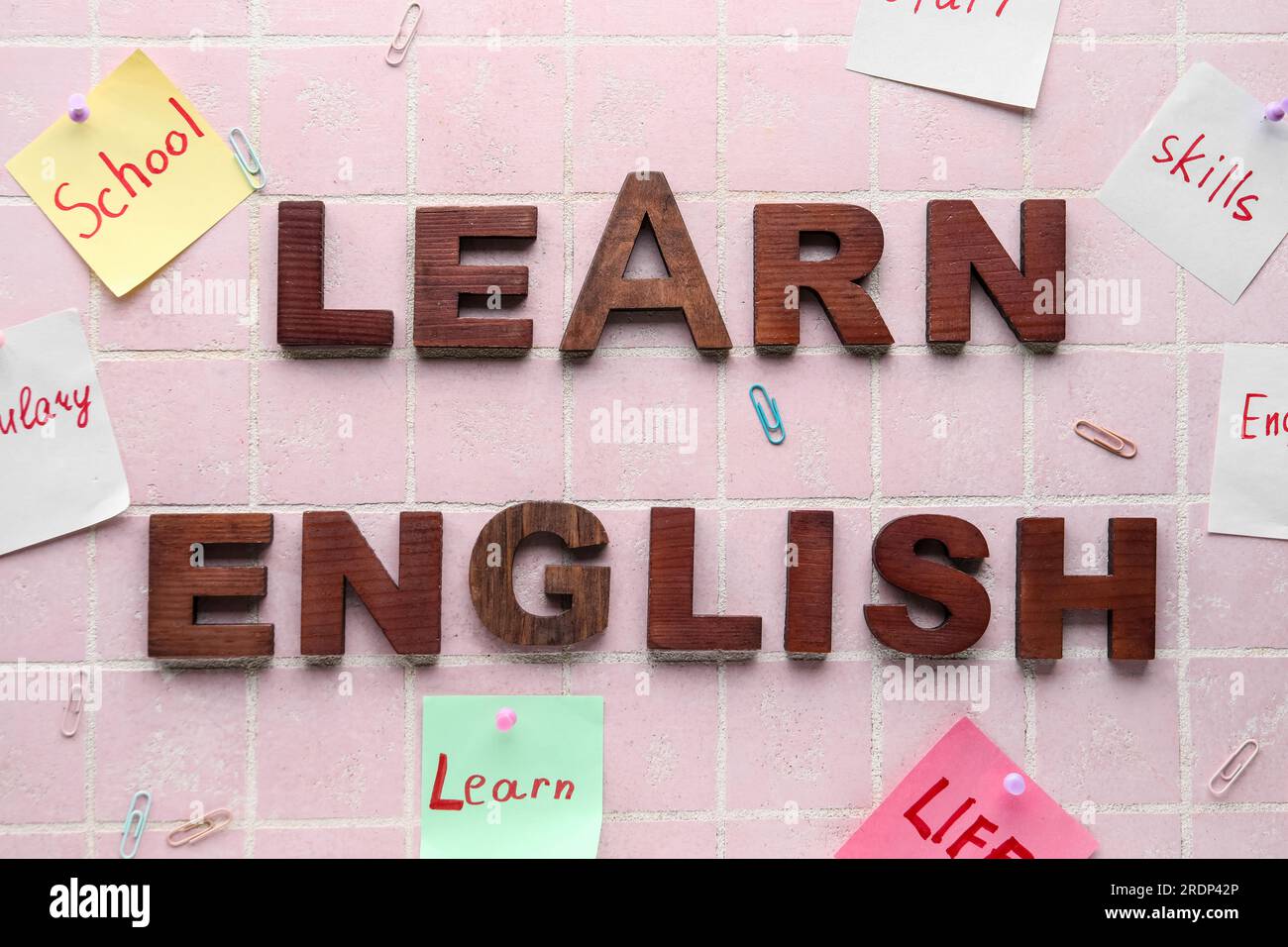 Sticky notes with different words and text LEARN ENGLISH on pink tile ...