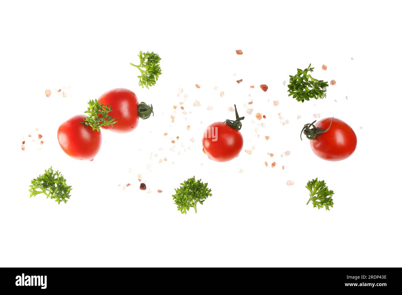 Flying, tomatoes, parsley and sea salt on white background Stock Photo ...